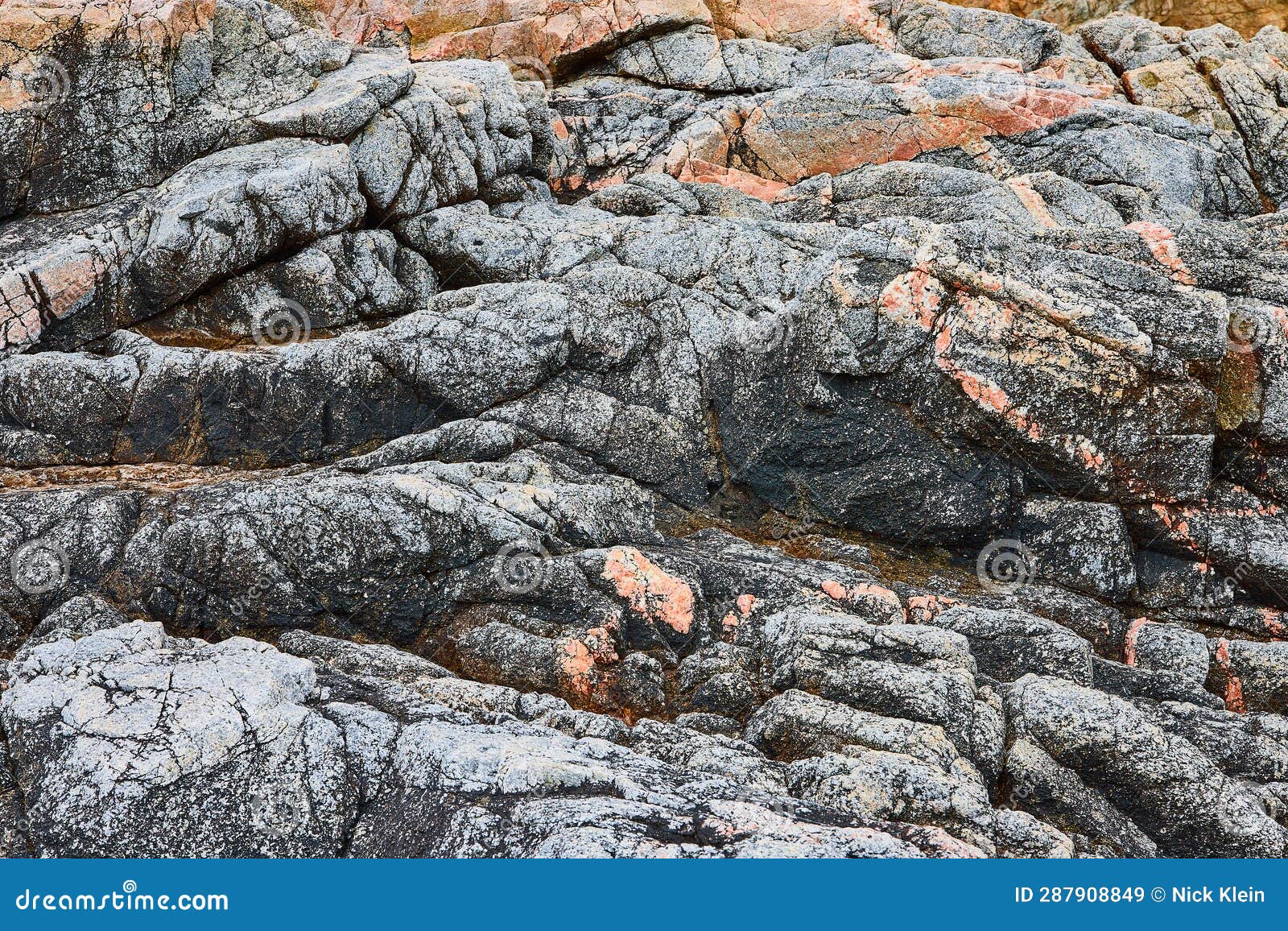 Light and Dark Grey Stony Cliff Wall with Tan Rock and Cracks in Stone ...