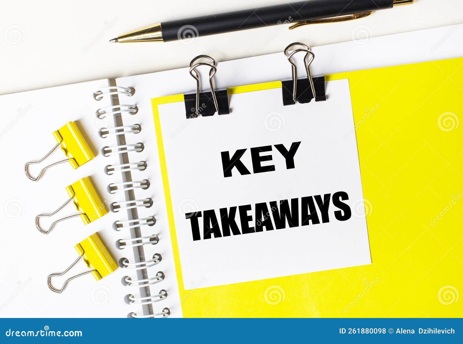 On A Light Desktop, A Pen, Yellow Paper Clips And A White Card With The ...