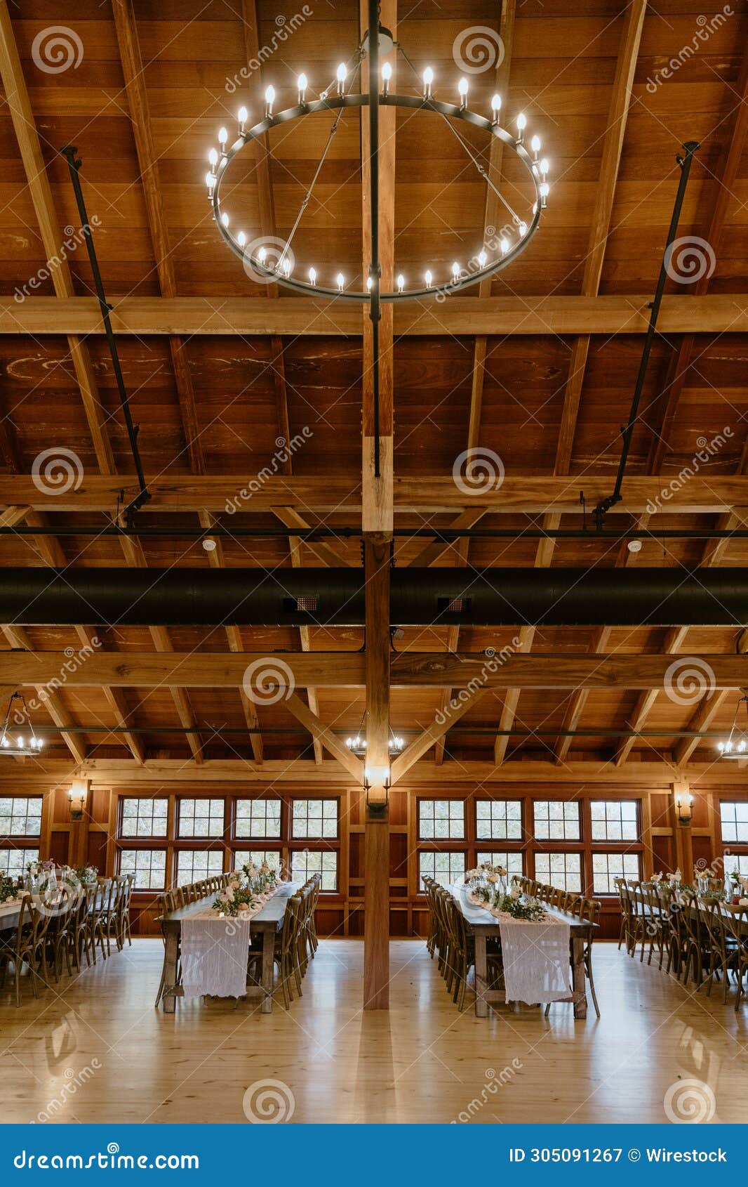 Light Fixture Hanging from Rafter Ceiling in Rustic Barn Reception Hall ...
