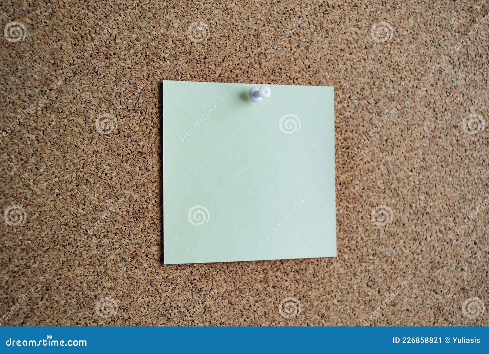 A Light Green Paper Note on a Cork Board, Attached with a White Pushpin ...