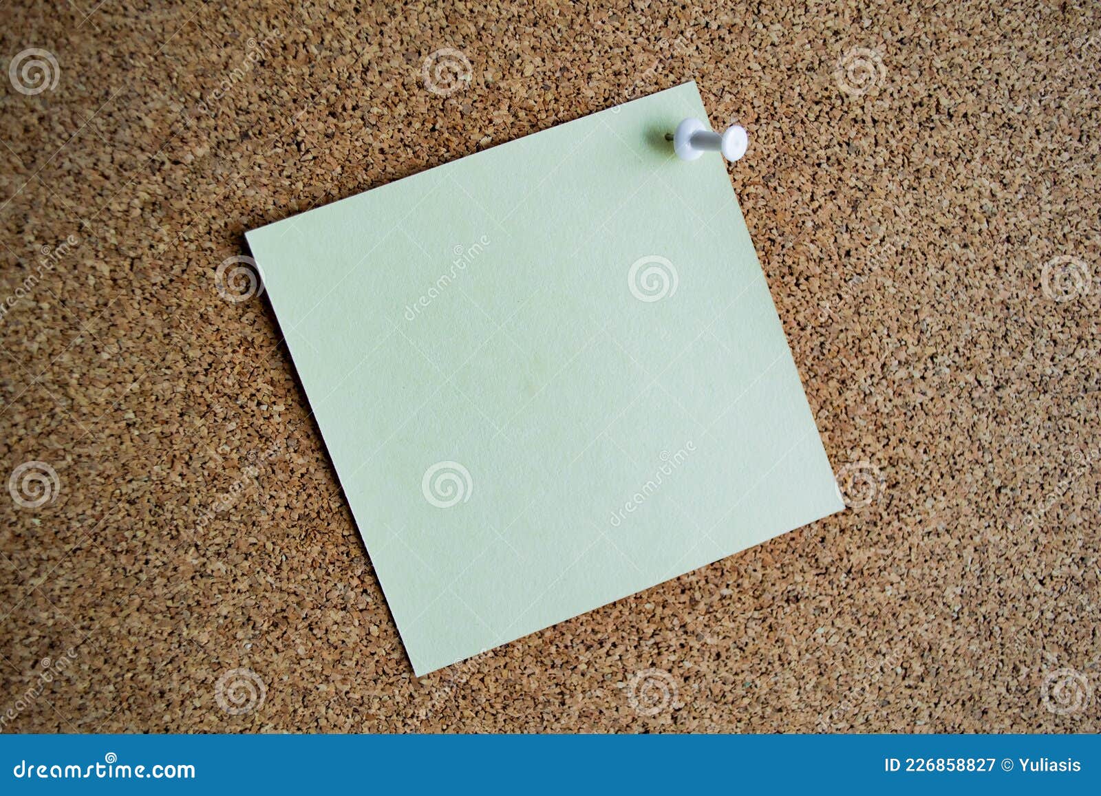 A Light Green Paper Note on a Cork Board, Attached with a White Pushpin ...