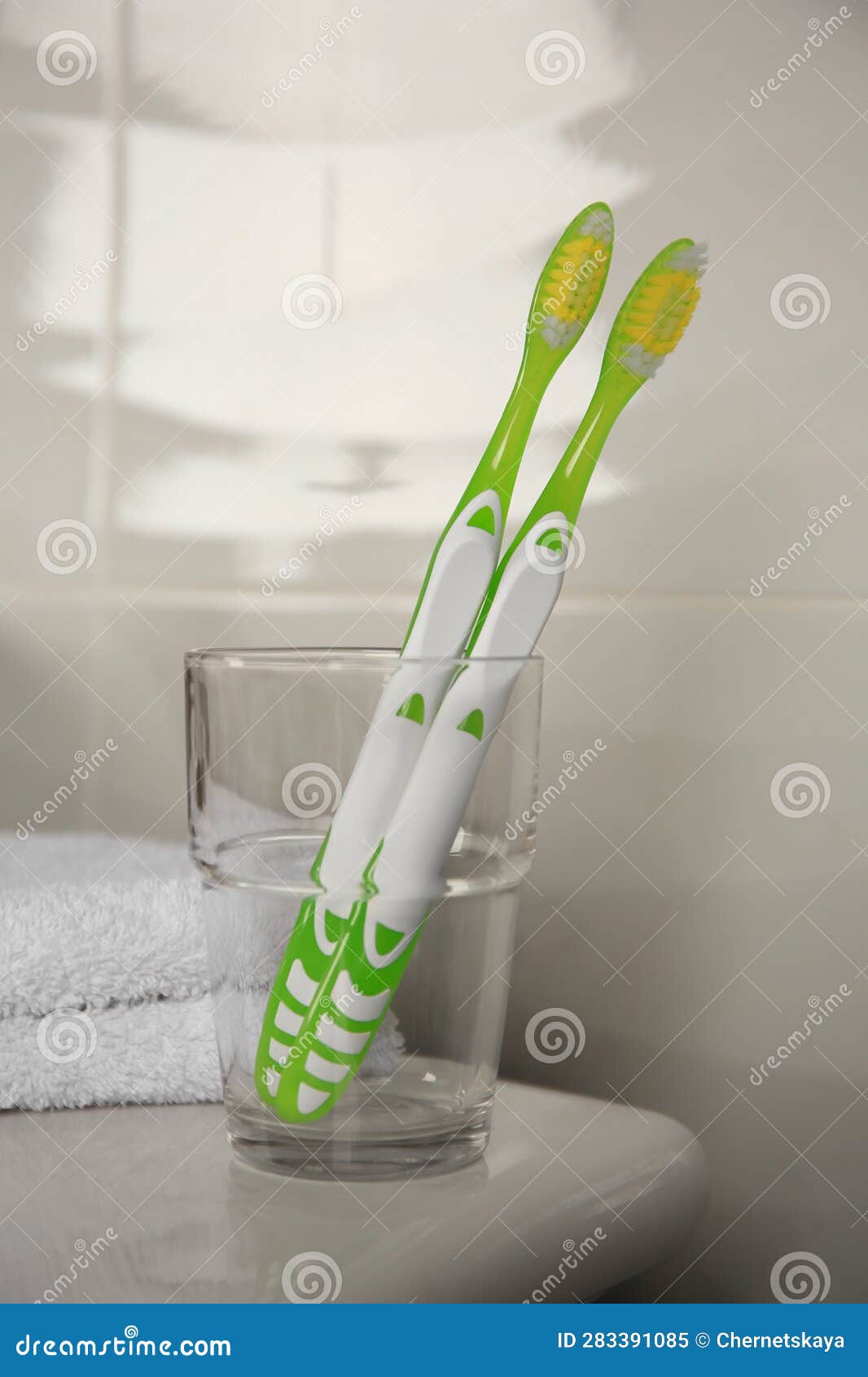 Light Green Toothbrushes in Glass Holder on Washbasin Stock Image ...