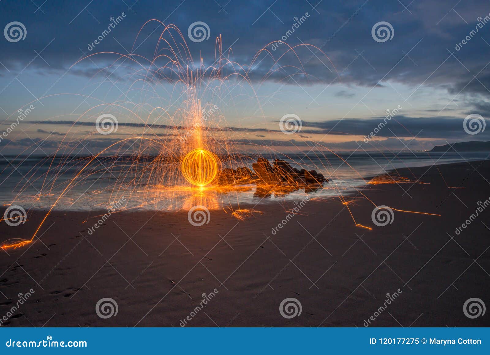 Light Painted Orb on a Beach with Rocks and a Sunset Stock Image ...