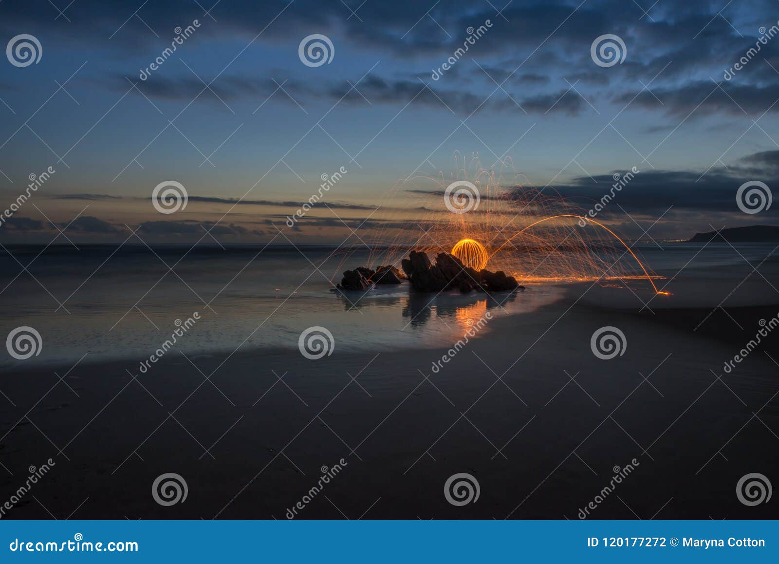 Light Painted Orb on a Beach with Rocks and a Sunset Stock Photo ...