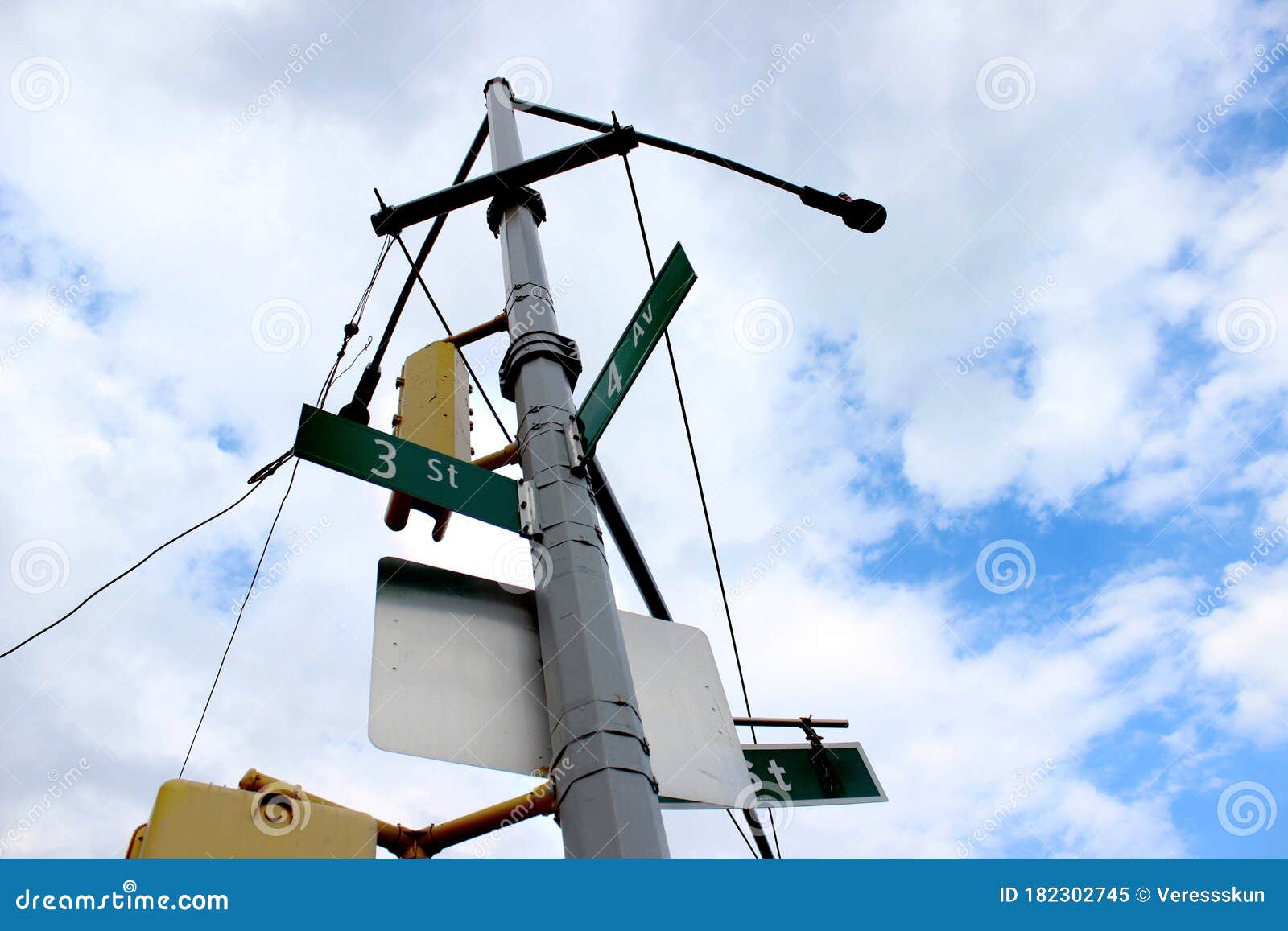 A Light Pole with a Traffic Light and the Designation 3 Streets and 4 ...