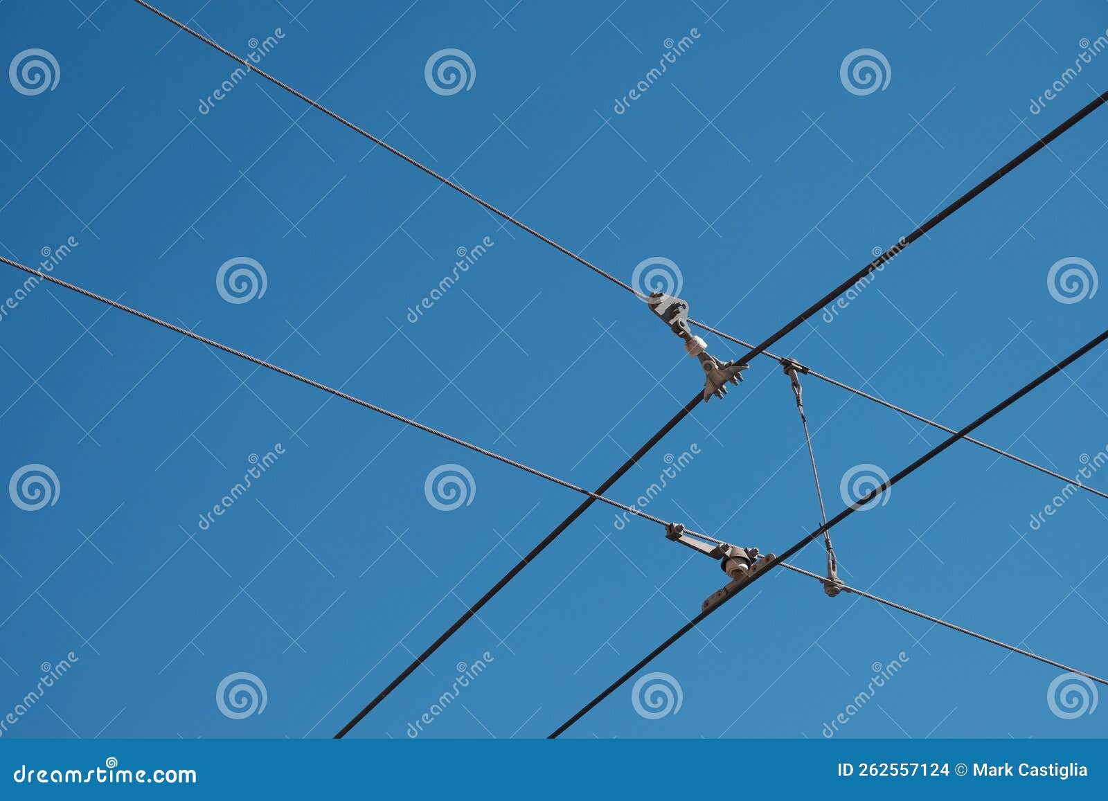 Light Rail Train Cables Cross in Clear Blue Sky Stock Photo - Image of ...