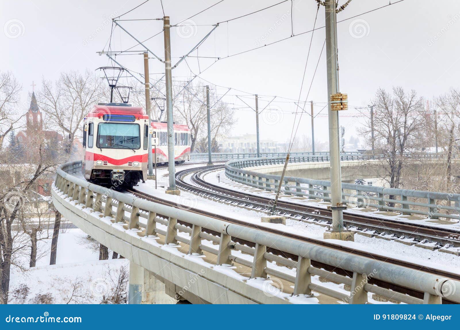Light Rail Train on a Curving Bridge on a Snowy Winter Day Stock Photo ...