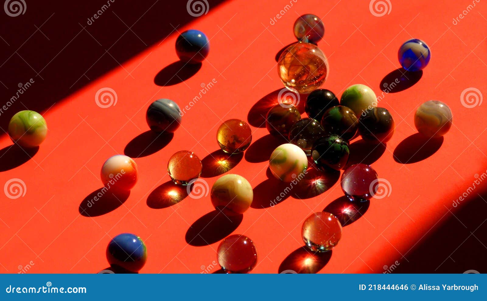 Light Reflecting through Glass Marbles on a Red Surface Stock Photo ...