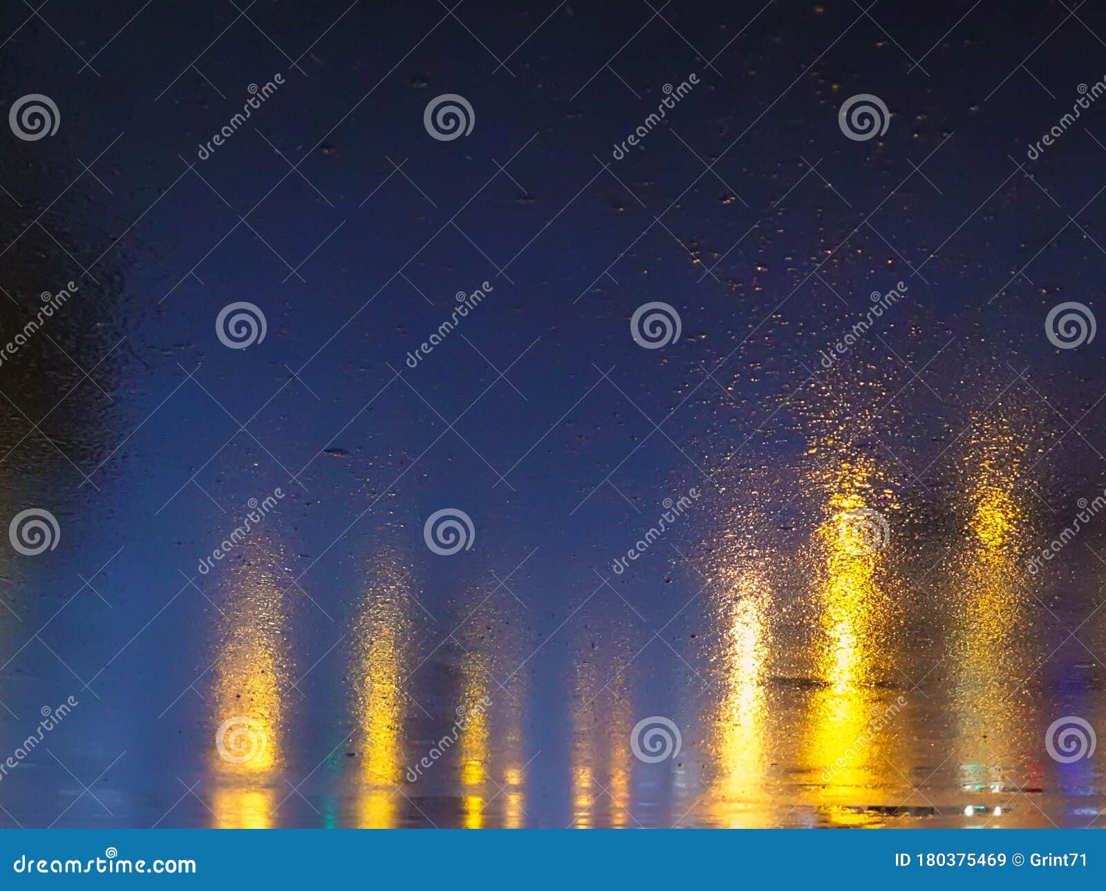 Light from Shop Windows is Reflected on the Wet Asphalt. View from the ...