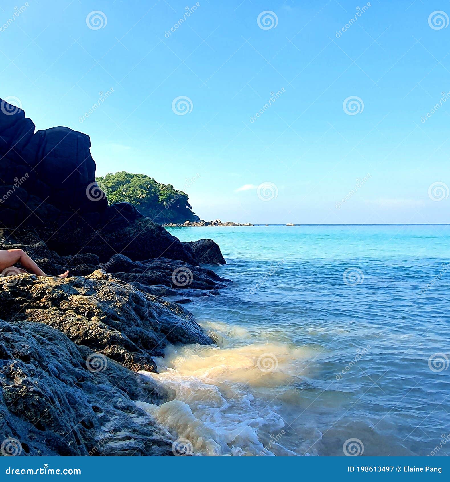Sunbathing on Rocks on the Secluded Beach. Light Steaming through the ...