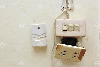 A Light Switch and Electrical Breaker with Damaged Wiring on the Wall ...
