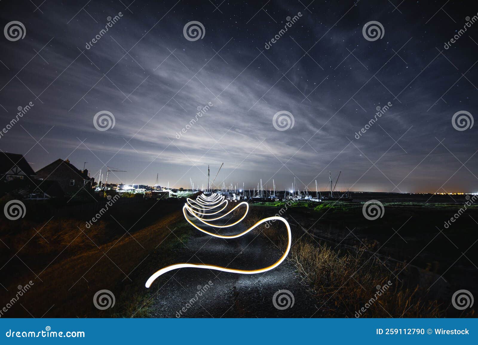 Light Trail on a Road Under a Dark Starry Cloudy Night Sky Stock ...