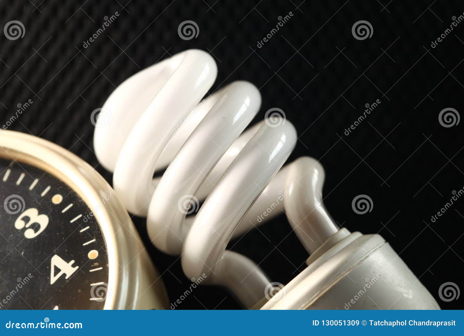 Lightbulb and Clock on Dark Background Scene. Stock Image - Image of ...