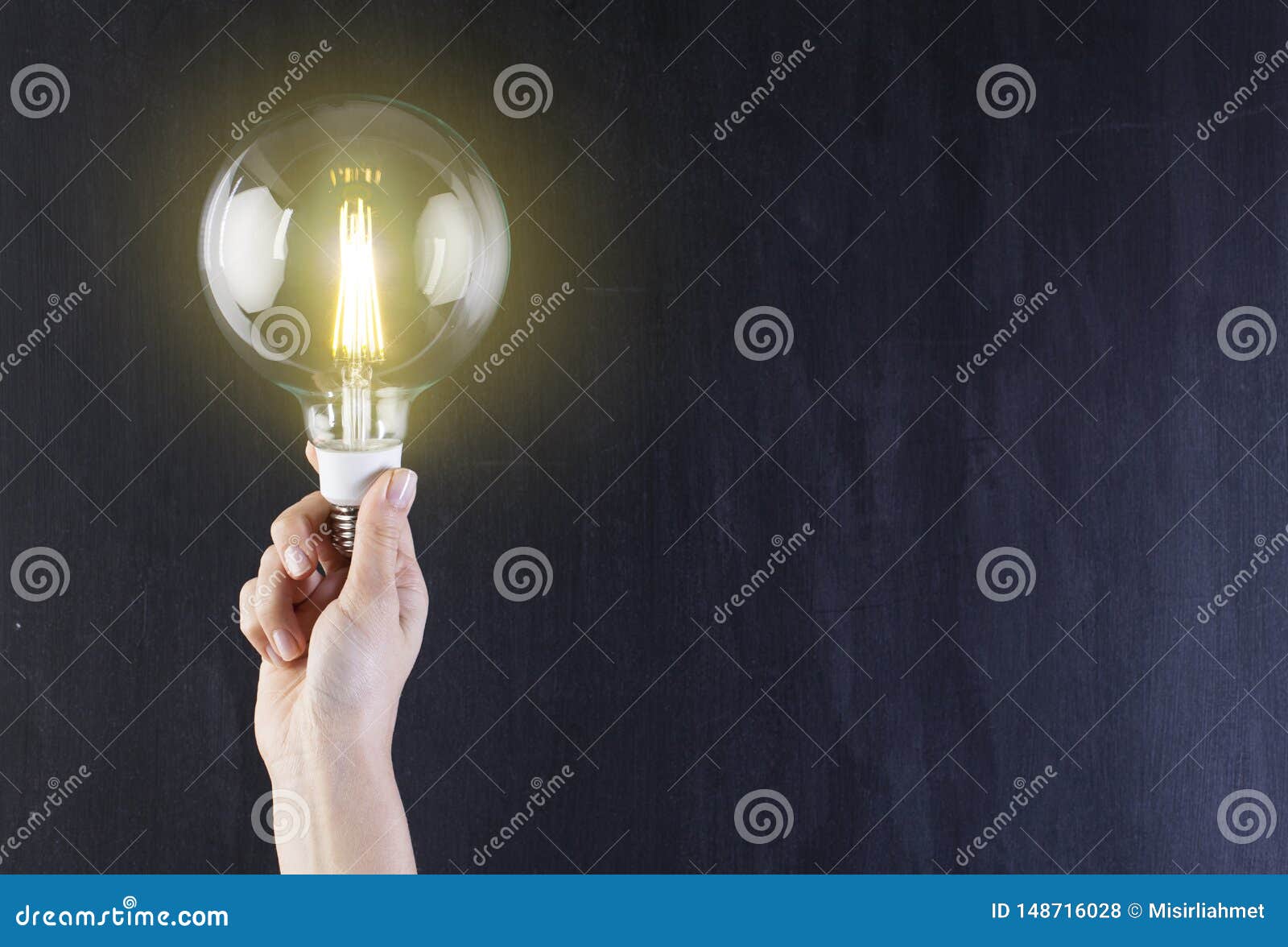 Hand holding lightbulb stock photo. Image of businessman - 148716028