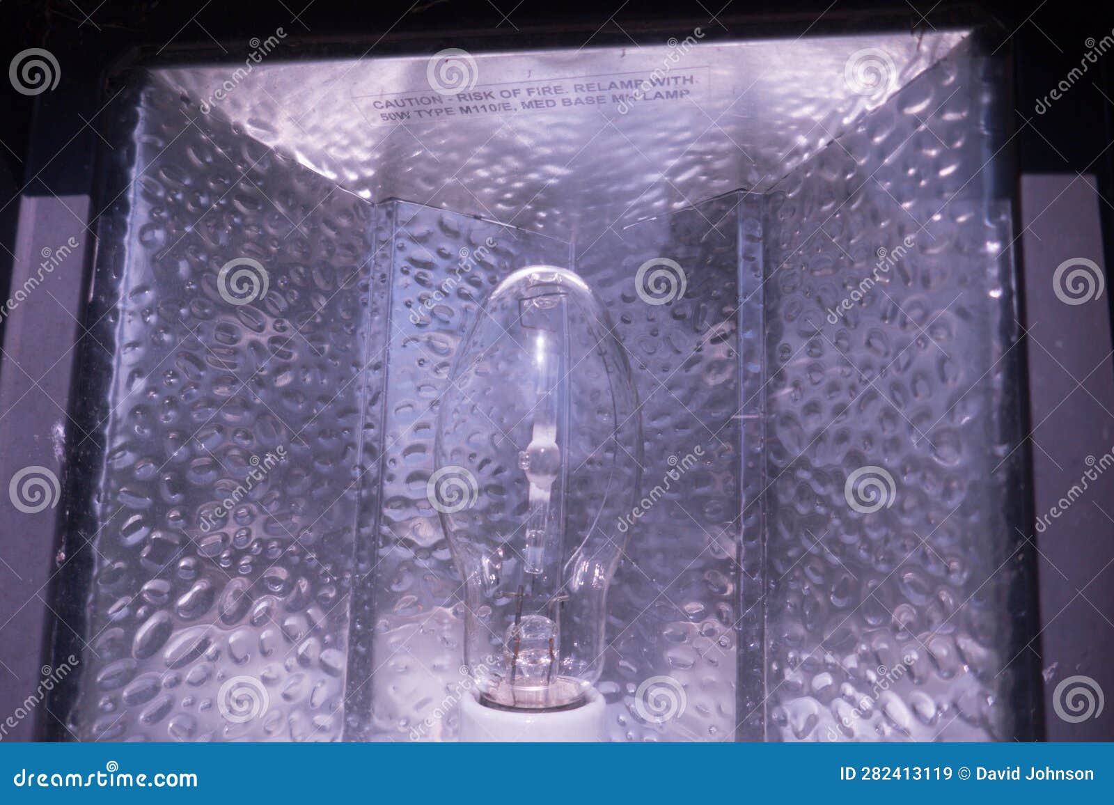 Lightbulb in Socket Inside Reflective Metal Outdoor Lighting Lamp Stock ...