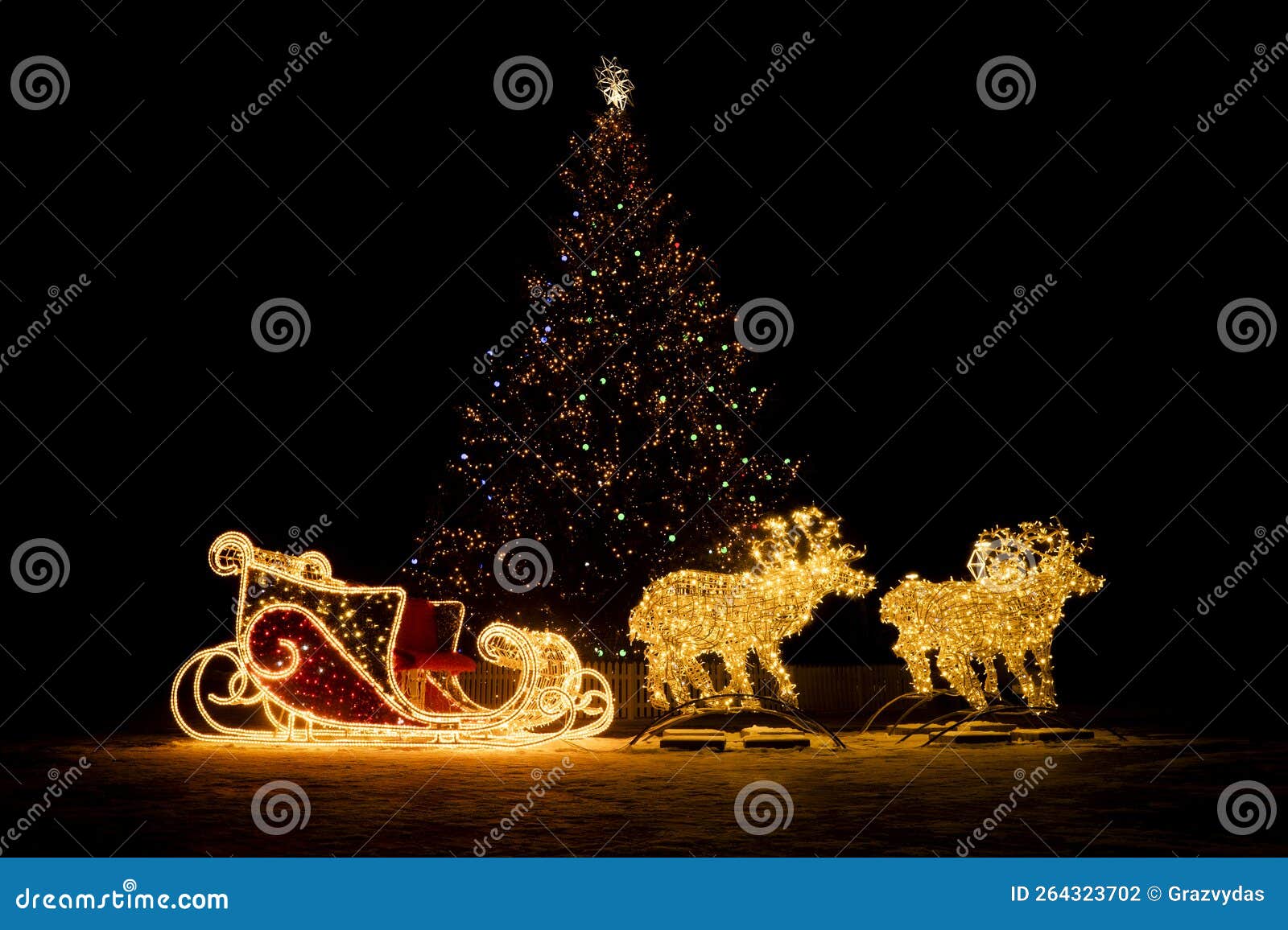 Lighted Christmas Reindeers with Sledge and Christmas Tree at Night ...