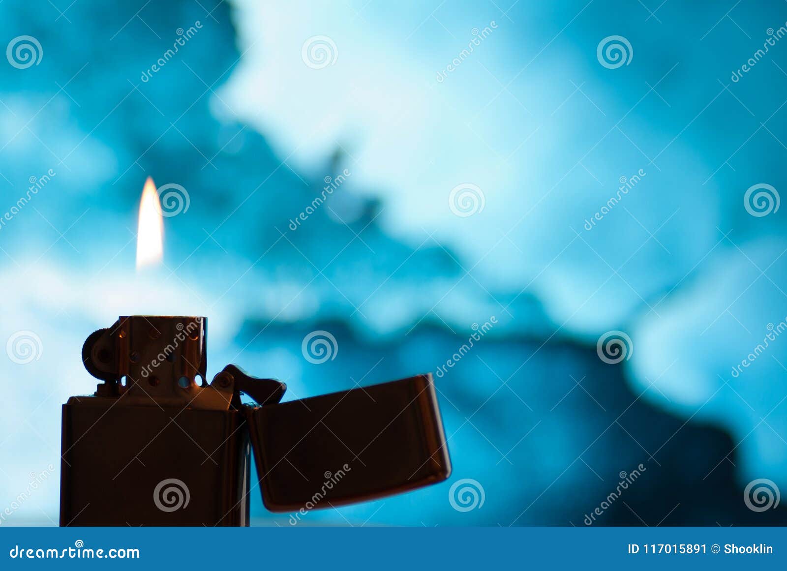 Lighted Lighter on Blue Cold Backgroung Stock Image - Image of lighted ...