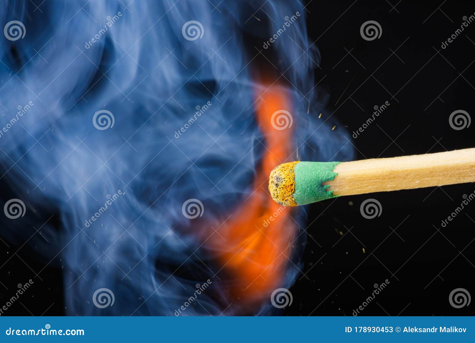 A Lighted Match with Smoke and Sparks on a Black Background, Macro ...
