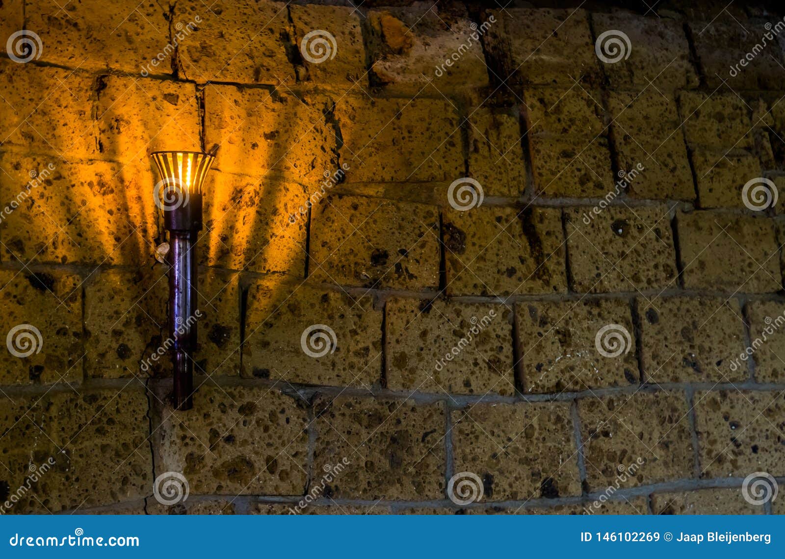 Lighted Medieval Castle Torch Hanging on a Stone Wall, Vintage Objects ...