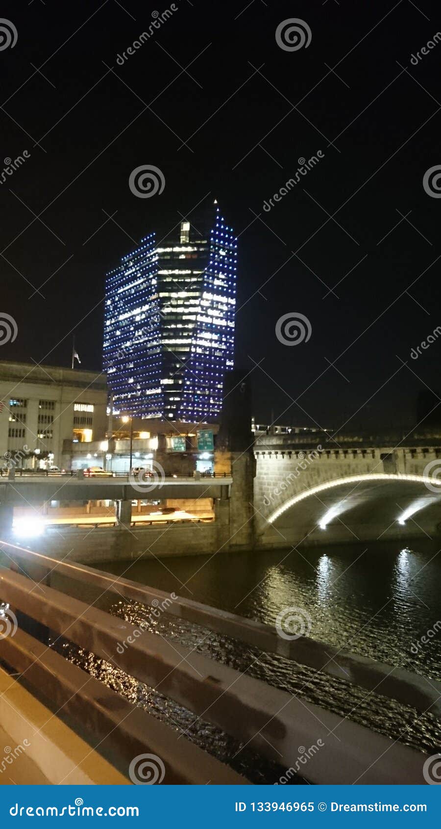 Lighted Skyscraper Overlooking Waterway Stock Image - Image of lighted ...
