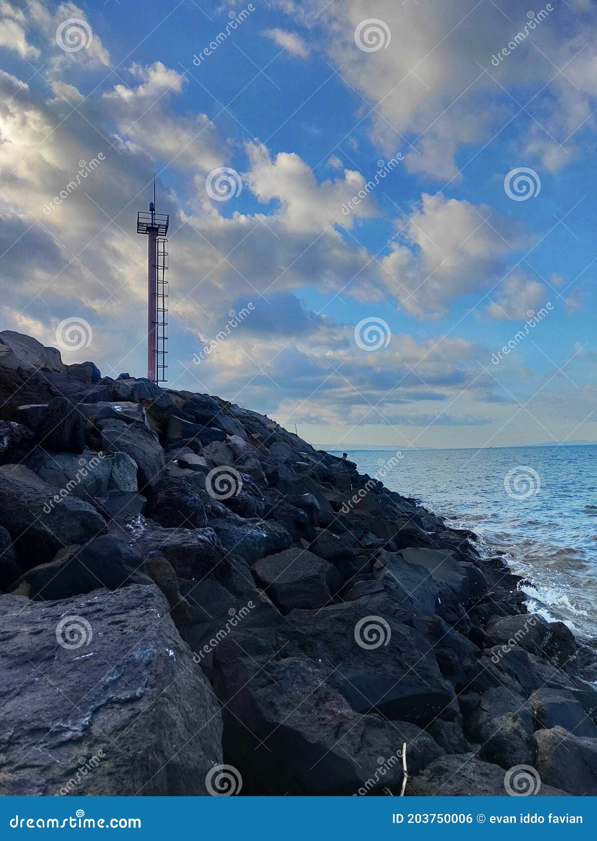 Lighthouse above the rocks stock photo. Image of rock - 203750006