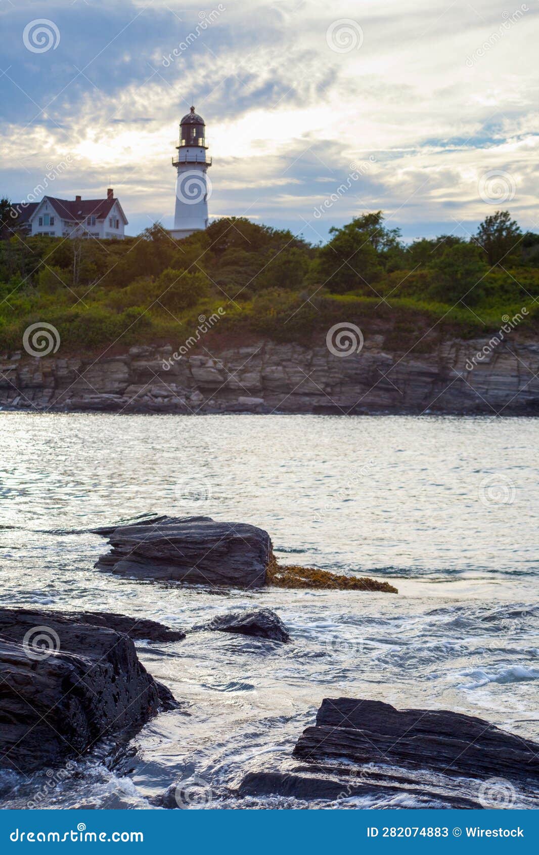 Lighthouse Atop a Jagged, Rocky Cliff Overlooking the Ocean Stock Image ...