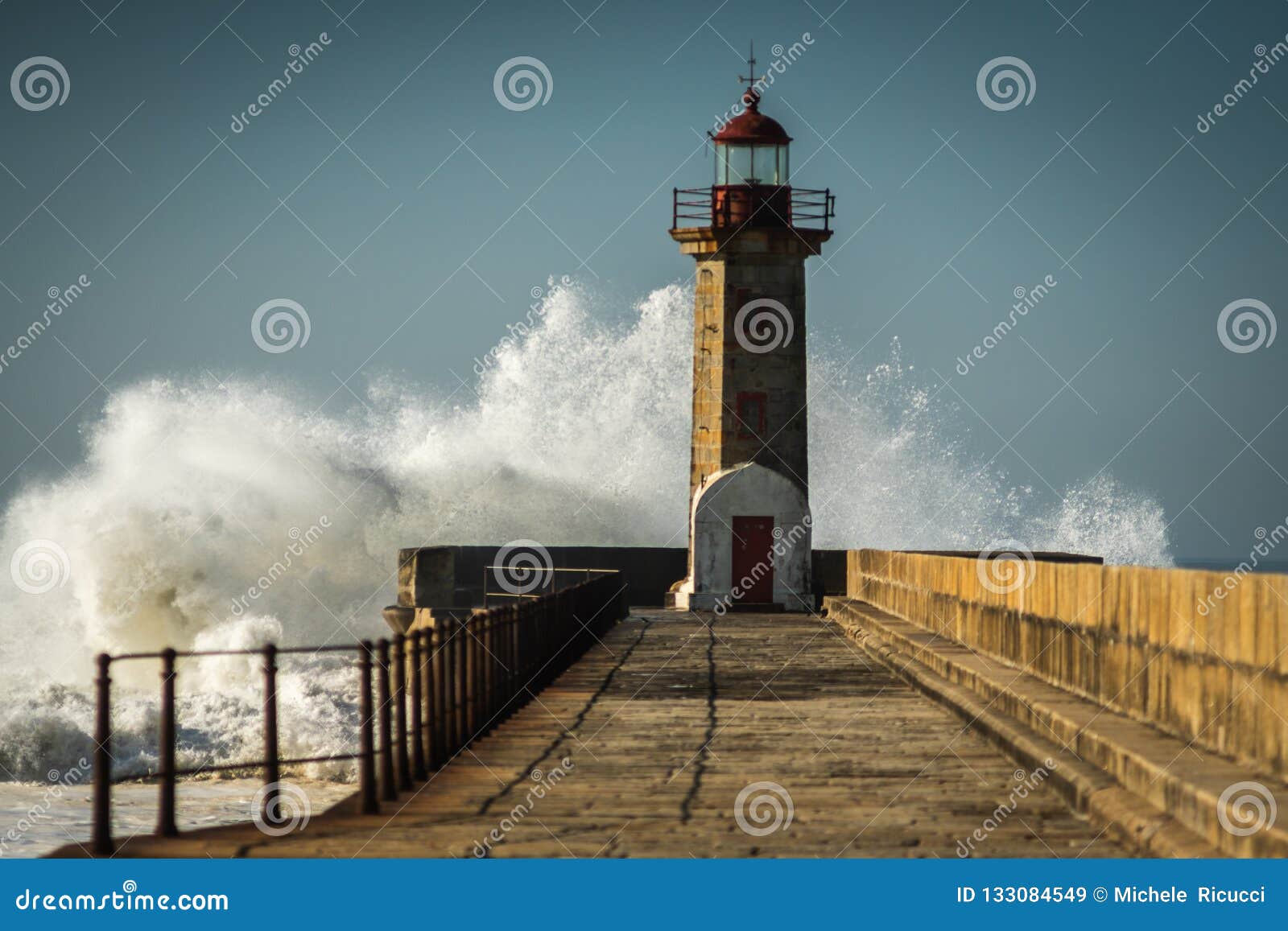 Lighthouse with a Big Wave of Water from the Ocean Stock Image - Image ...