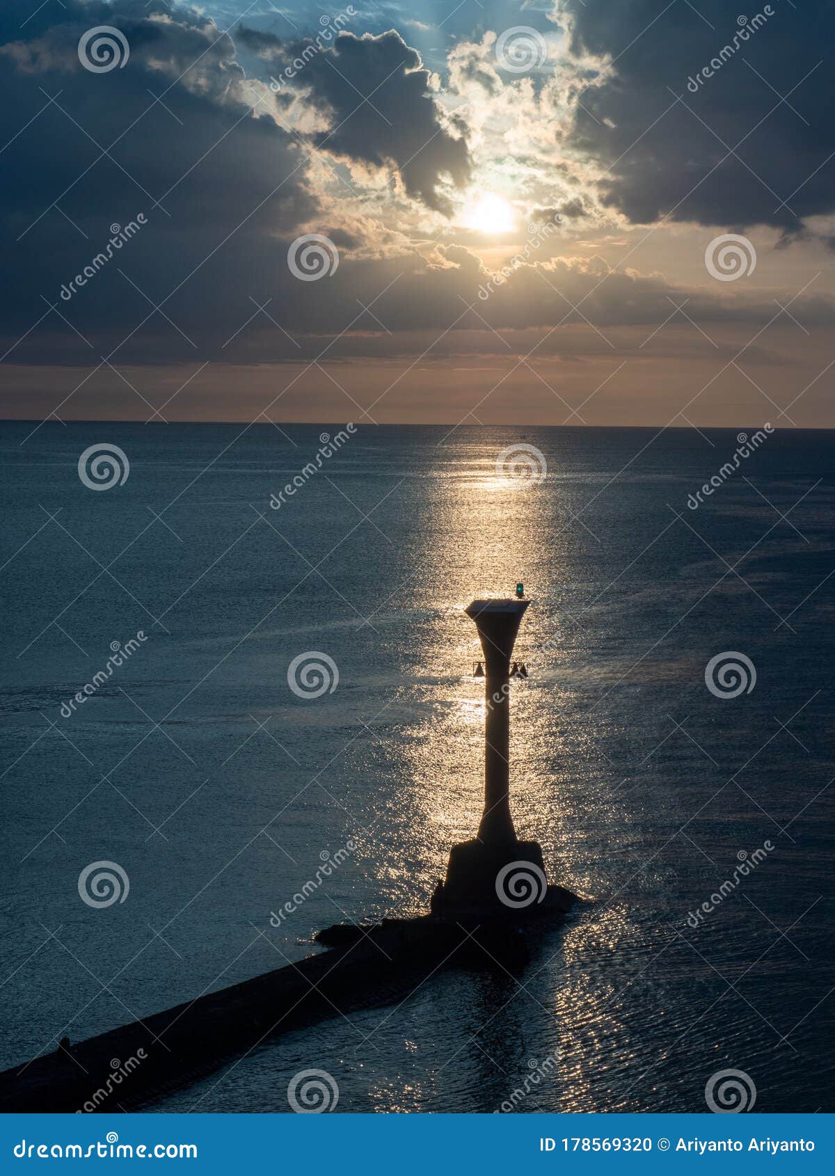 Lighthouse and a Boat Over the Calm Sea on Sunset Stock Photo - Image ...