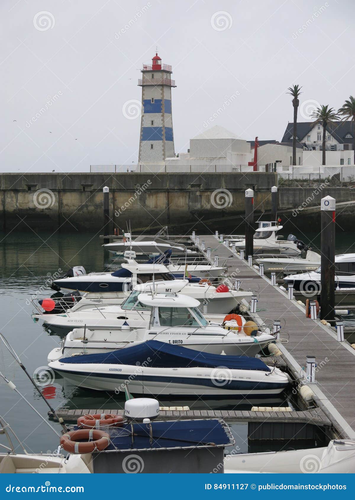 Lighthouse And Boats On Waterfront Picture. Image: 84911127