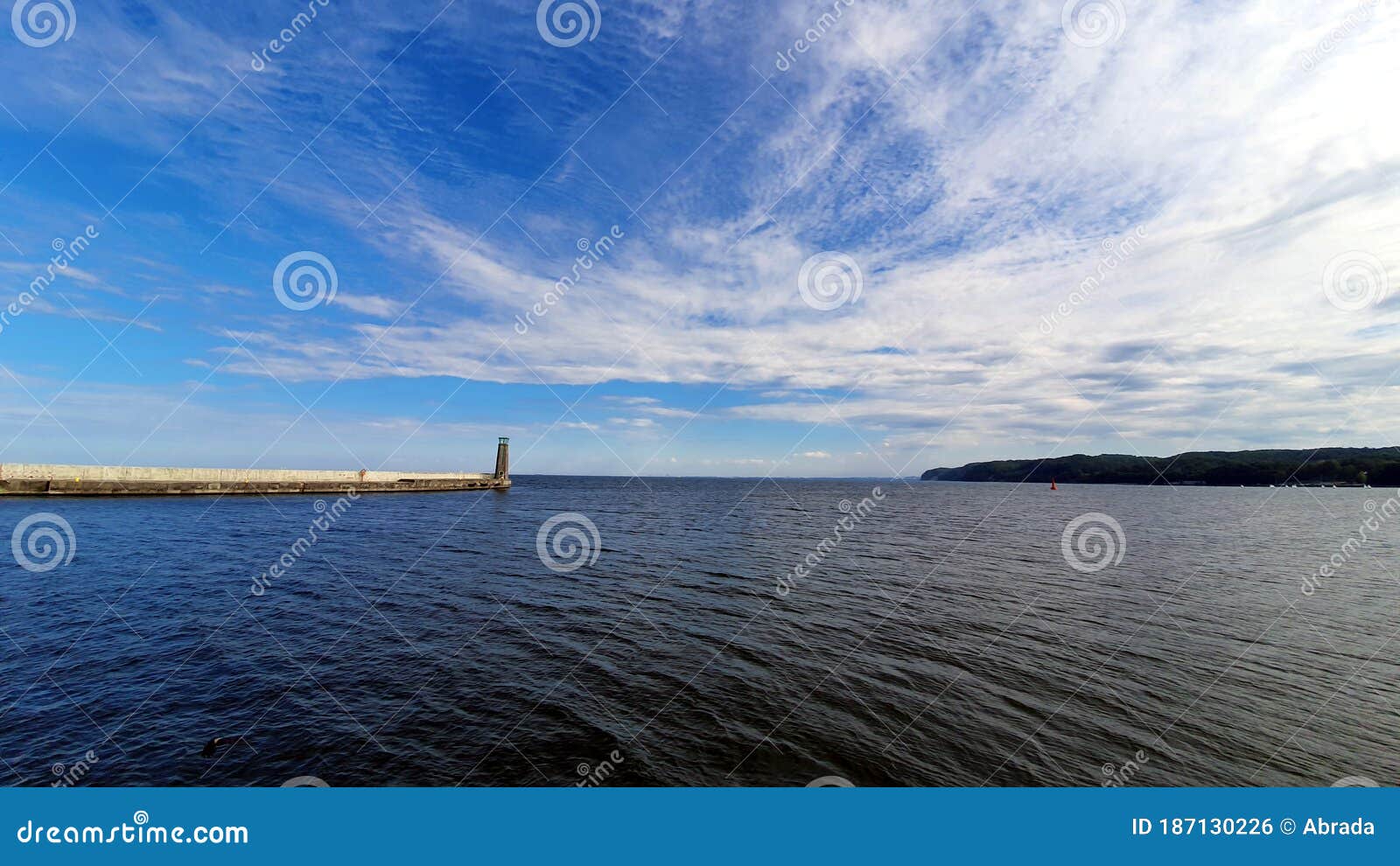 Lighthouse on a calm sea stock photo. Image of calm - 187130226