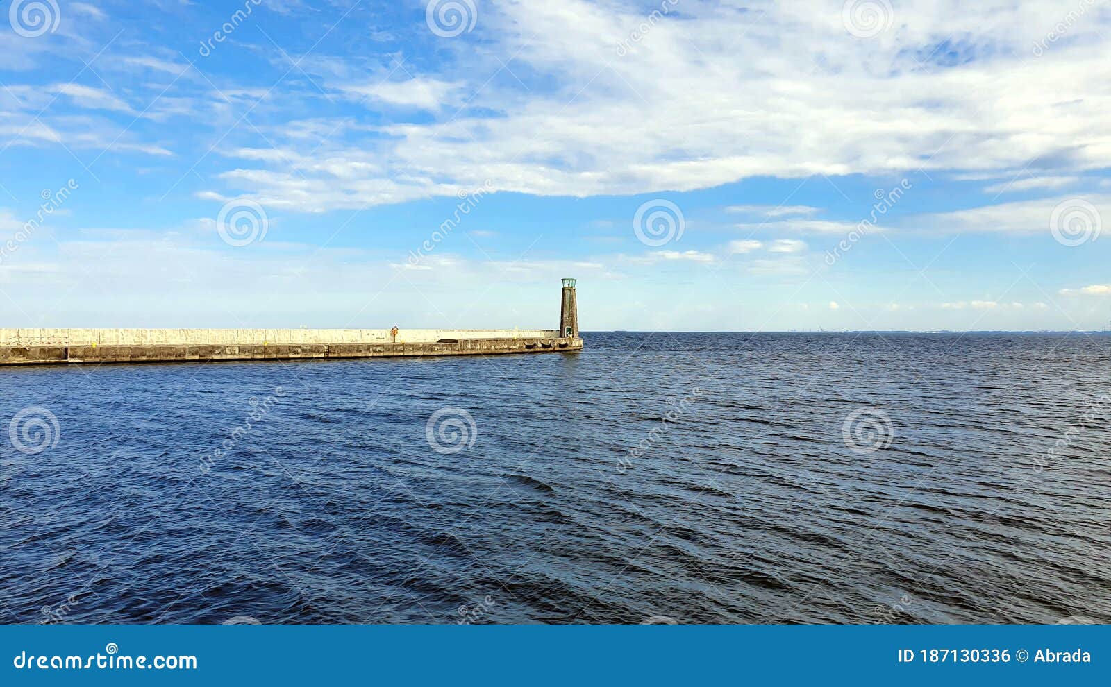 Lighthouse on a calm sea stock photo. Image of white - 187130336