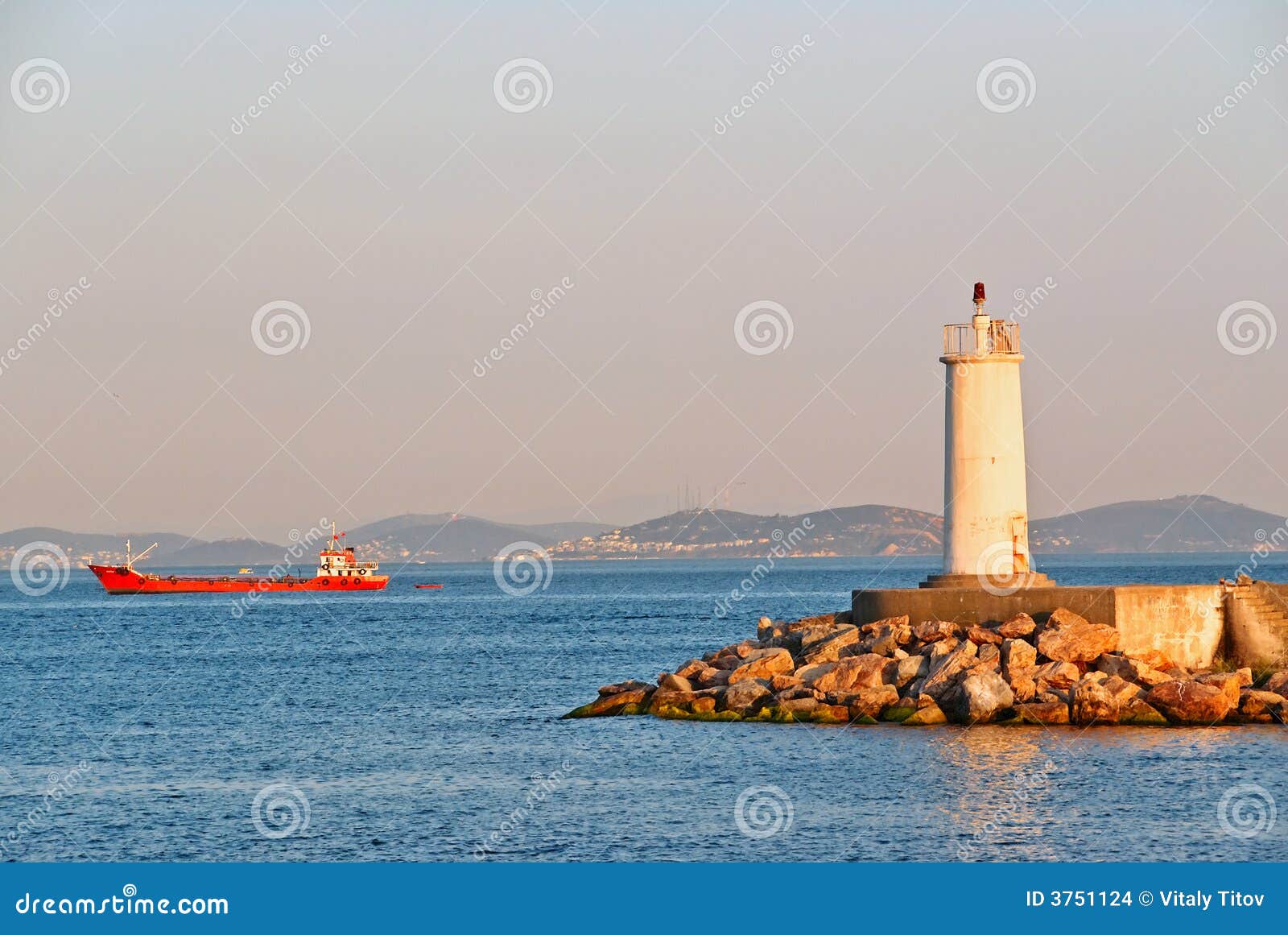 Lighthouse & Cargo Ship Stock Photo - Image of horizon, direction: 3751124