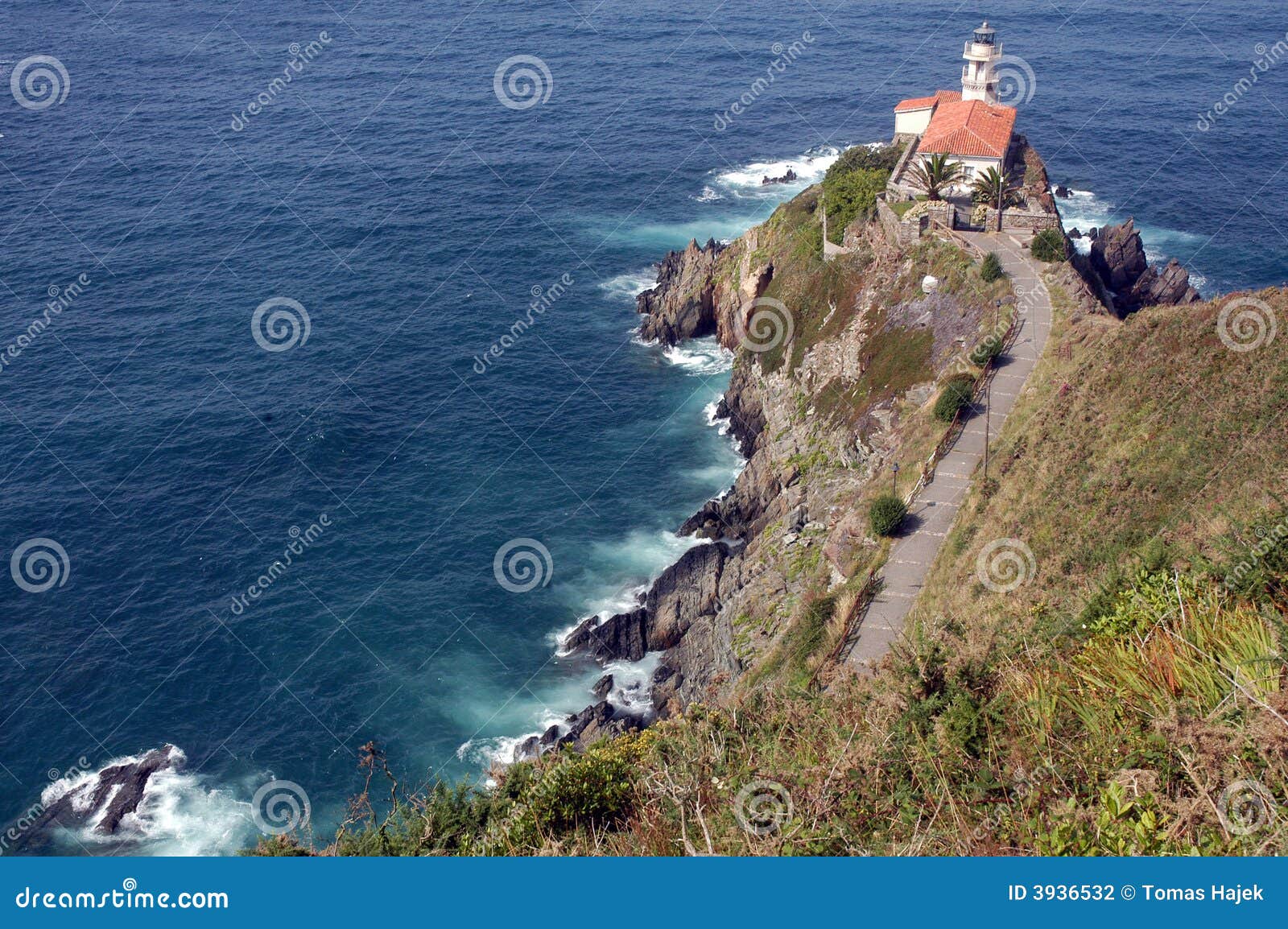 Lighthouse on cliff by sea stock photo. Image of path - 3936532