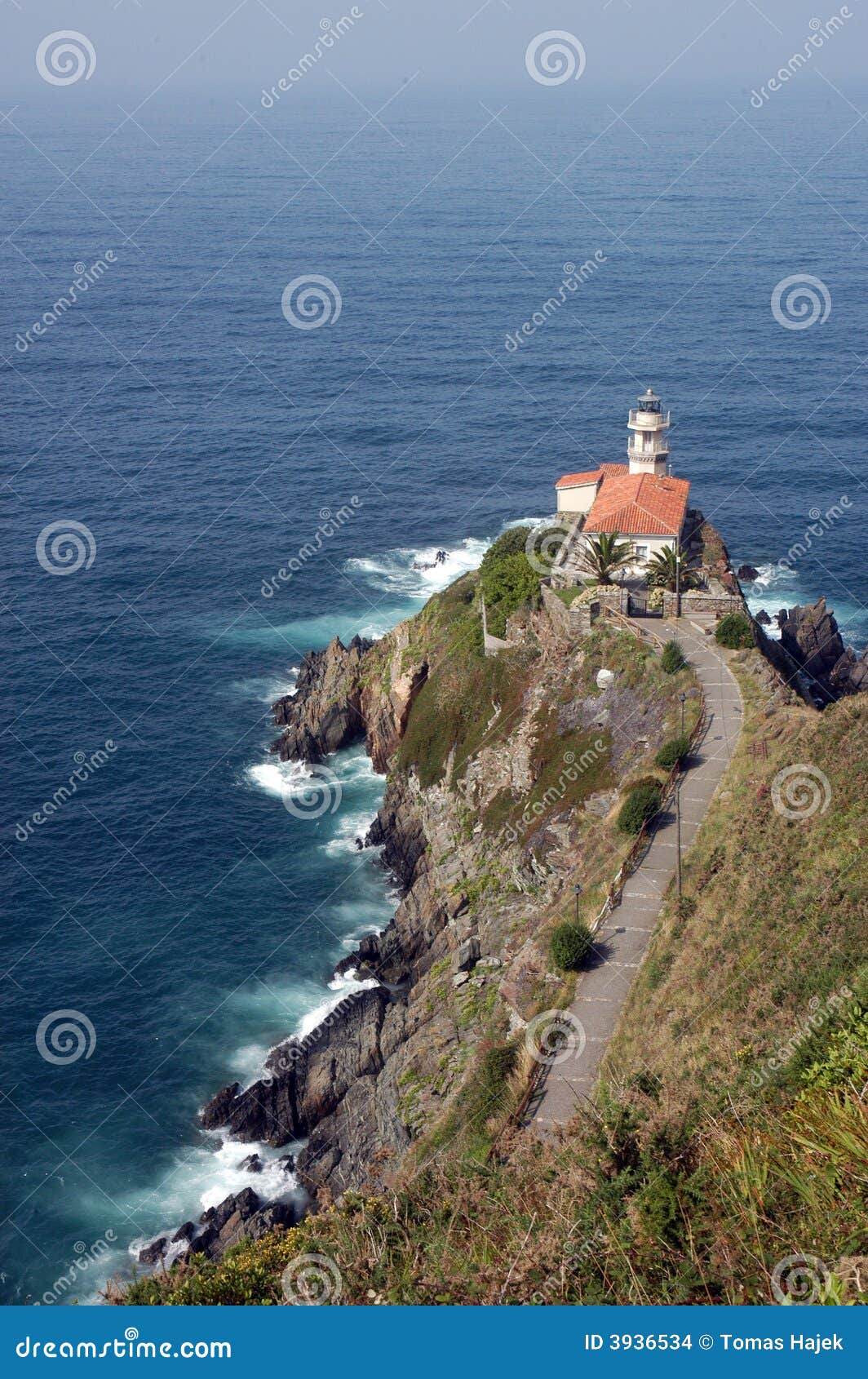 Lighthouse on cliff by sea stock photo. Image of scenery - 3936534