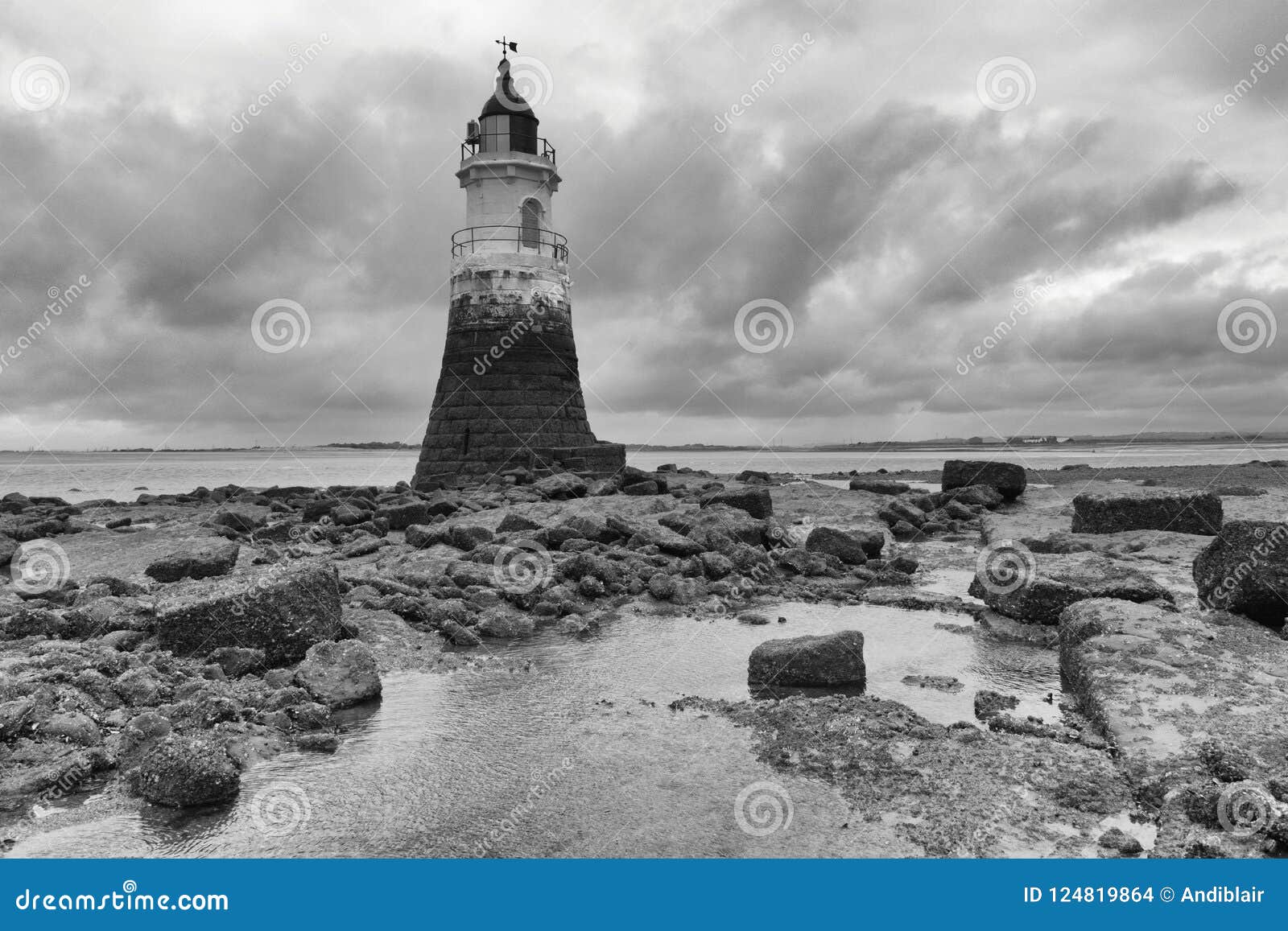 Lighthouse on a cloudy day stock photo. Image of hazard - 124819864