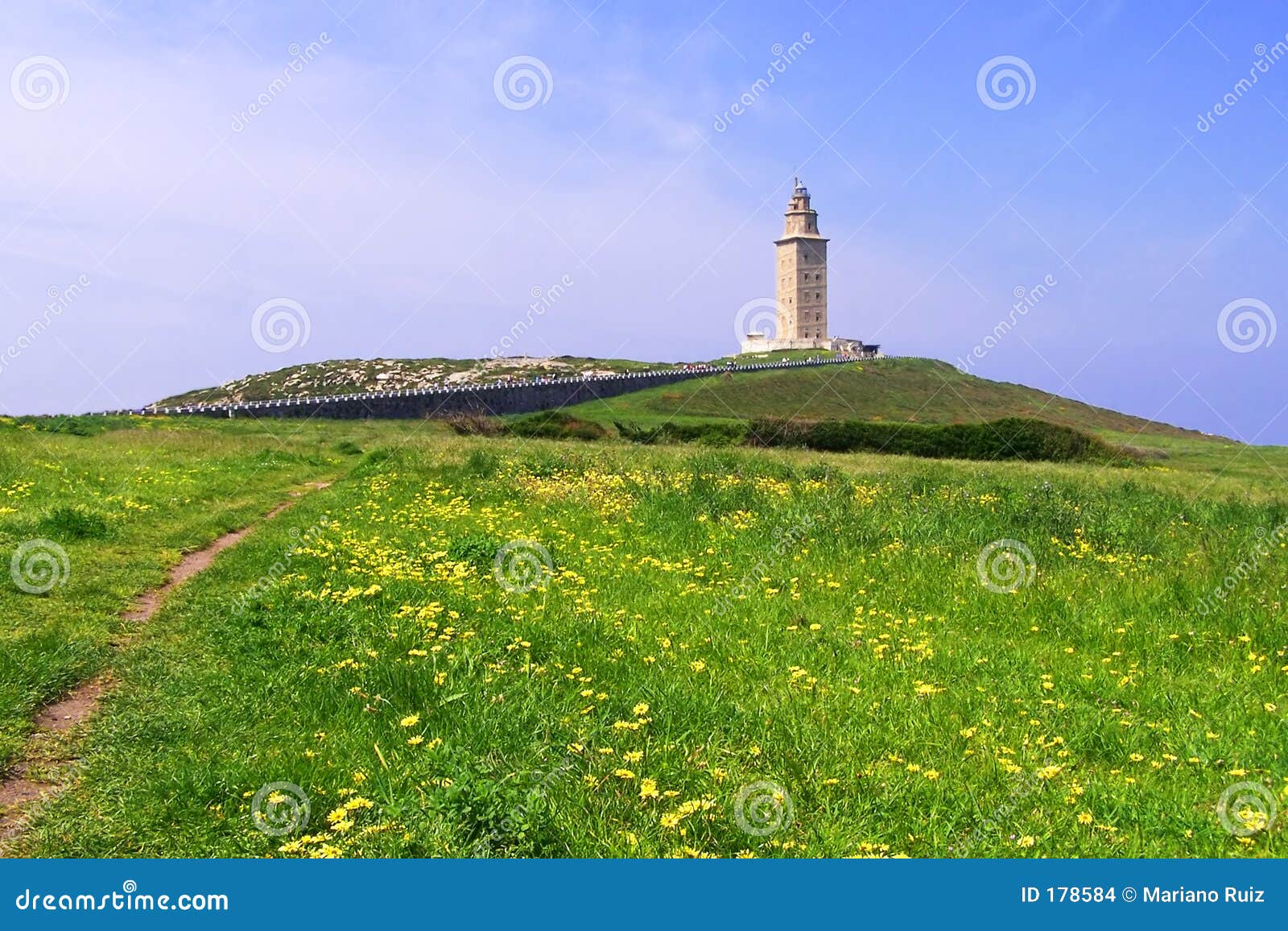 Lighthouse at the Distance in a Green Field Stock Photo - Image of ...