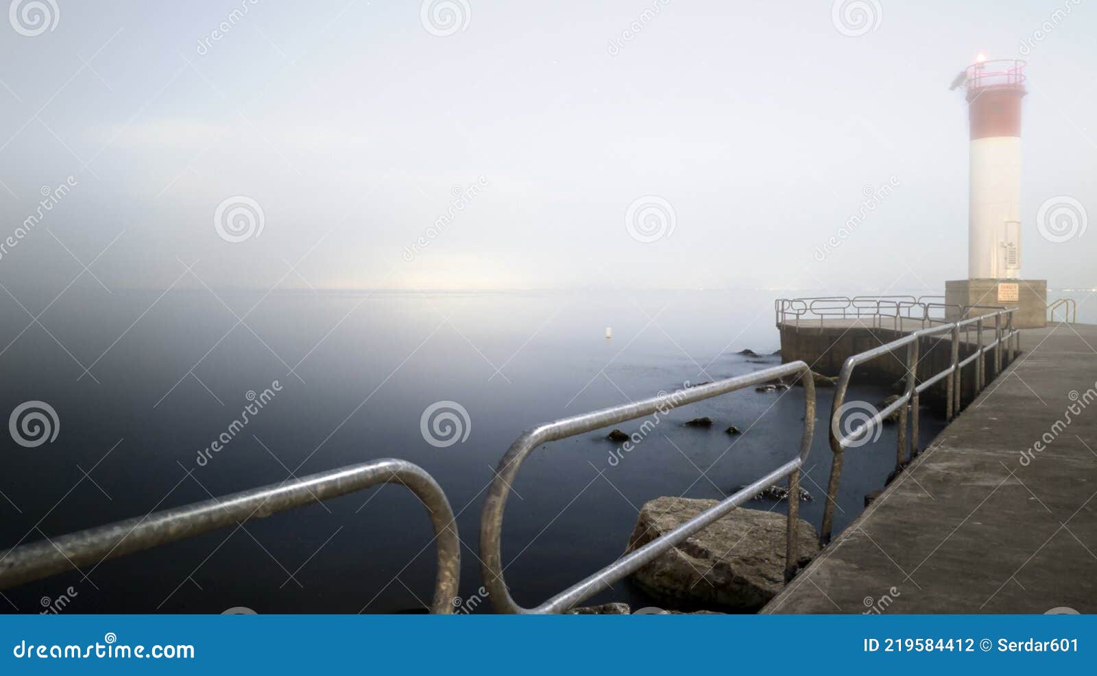 Lighthouse in fog stock photo. Image of ocean, beach - 219584412