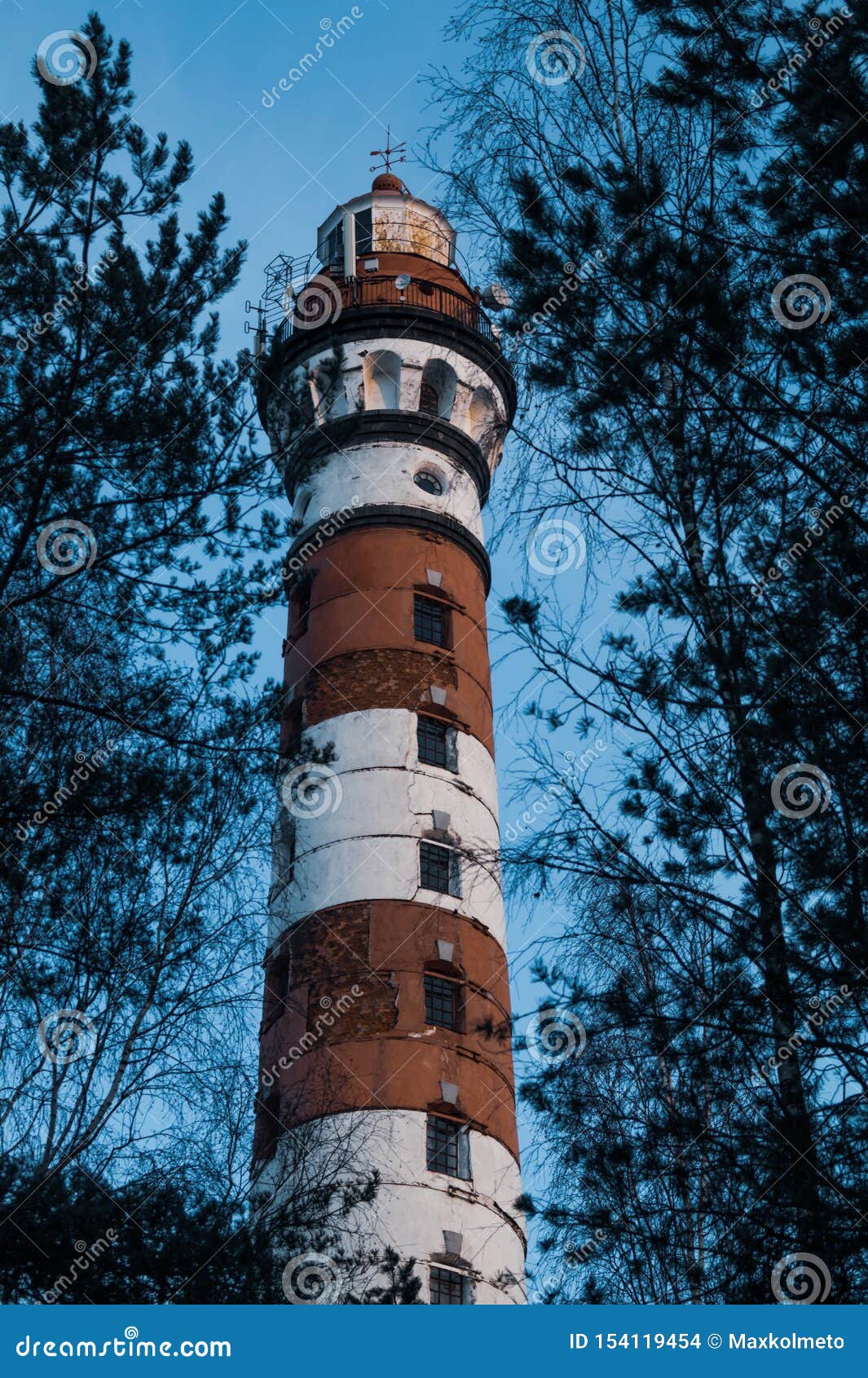 Lighthouse in the Forest between the Trees. Red and White Lighthouse ...
