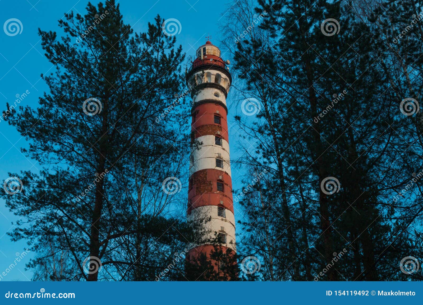 Lighthouse in the Forest between the Trees. Red and White Lighthouse ...