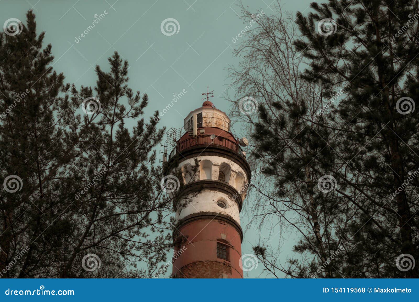 Lighthouse in the Forest between the Trees. Red and White Lighthouse ...