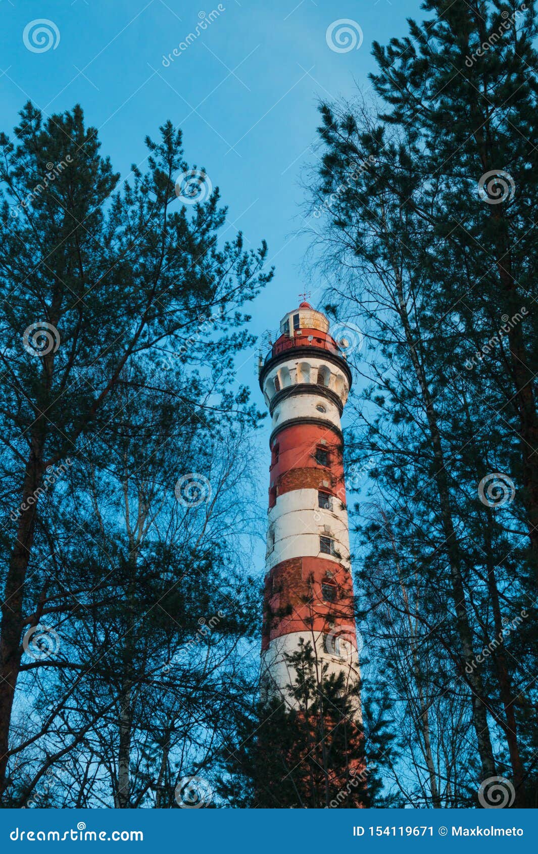 Lighthouse in the Forest between the Trees. Red and White Lighthouse ...