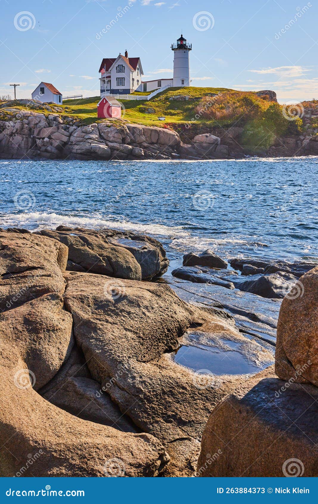 Lighthouse on Island from Mainland with Boulders and Puddles Stock ...