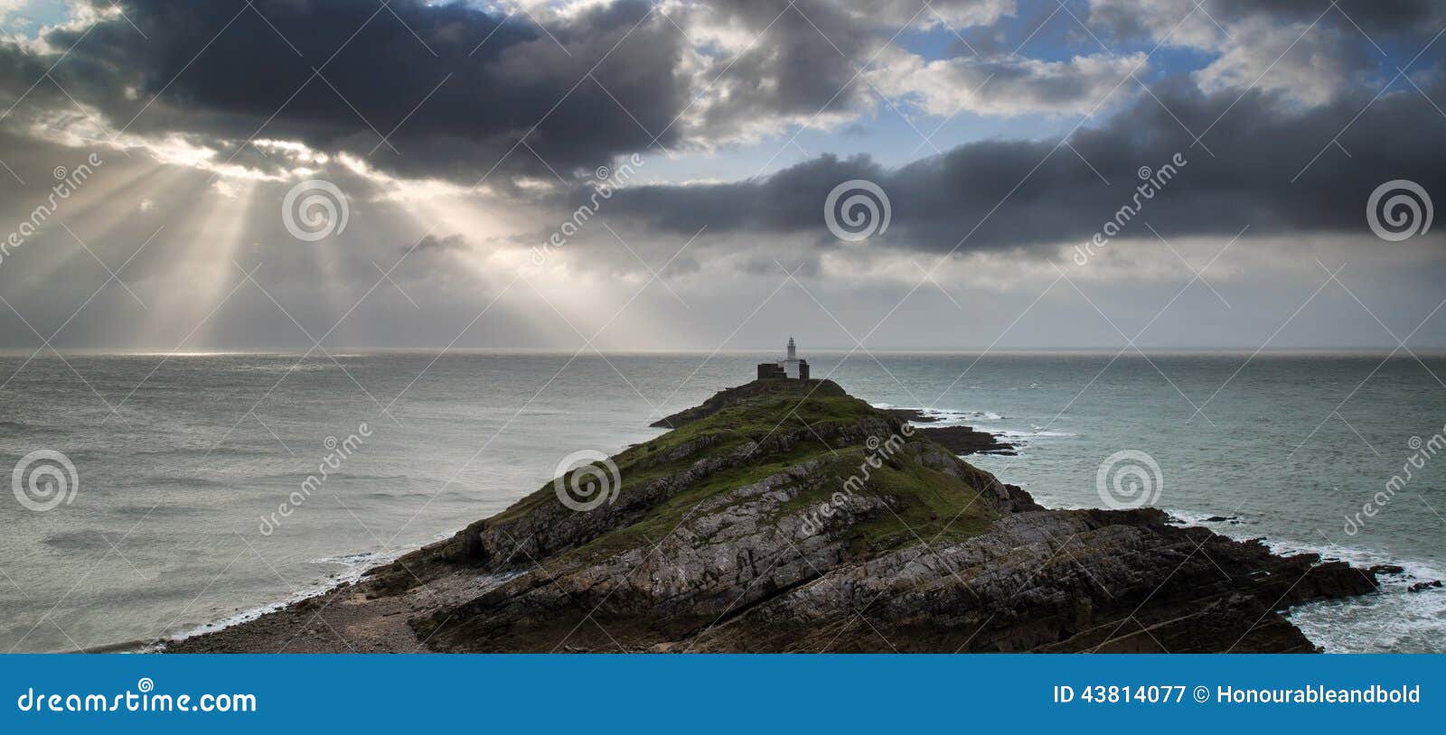 Lighthouse Landscape with Stormy Sky Over Sea with Rocks in Fore Stock ...