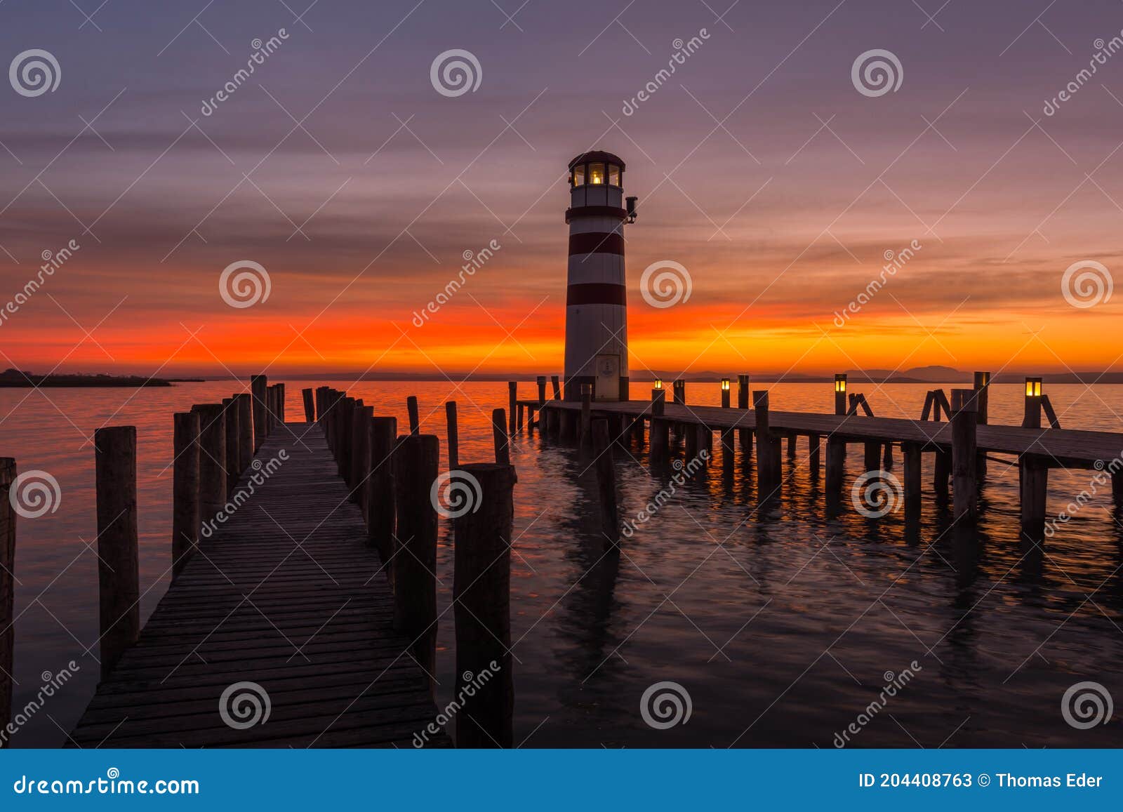 Lighthouse with Lantern on a Jetty from a Lake while Sunset Stock Image ...