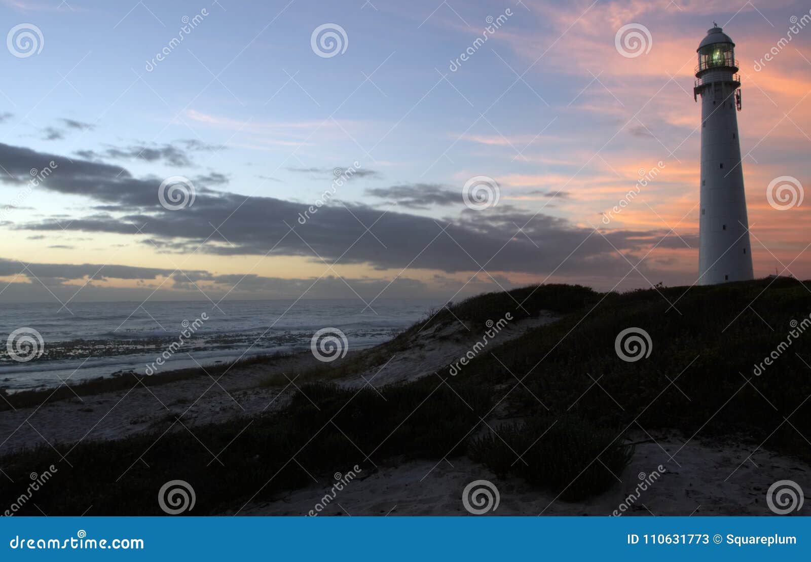 Lighthouse Lit Up by the Last Light of the Sun. Stock Image - Image of ...