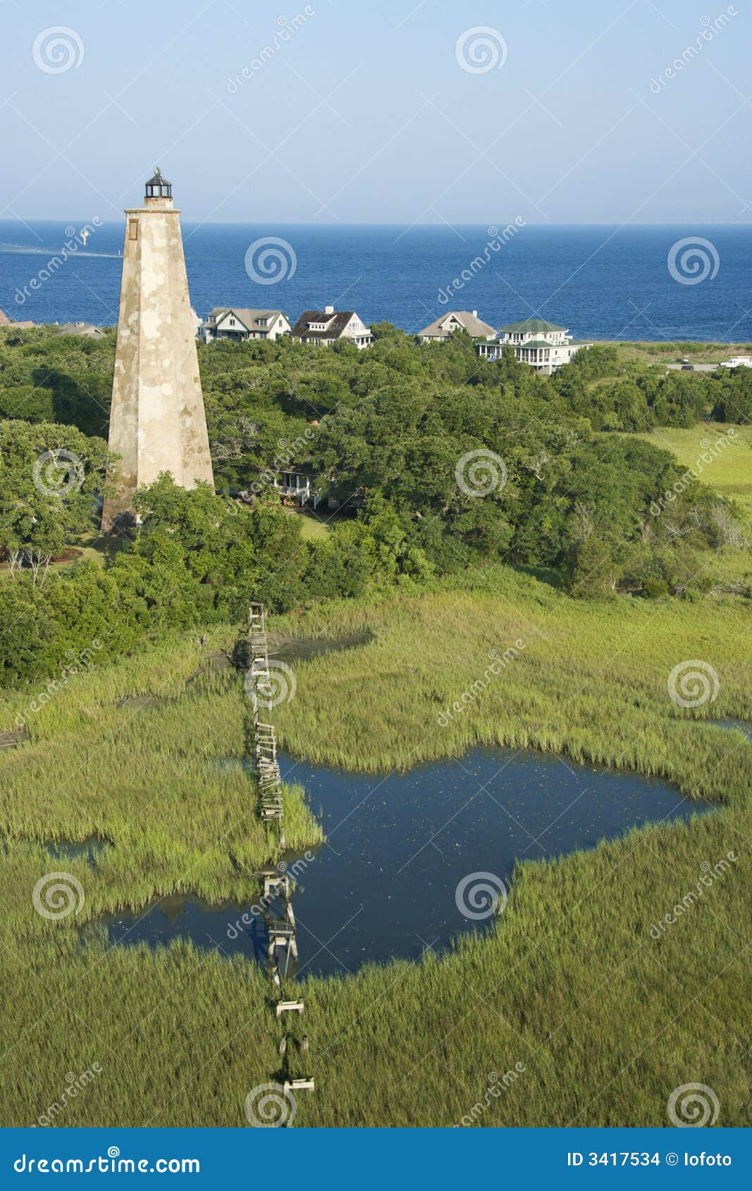 Lighthouse in marsh. stock photo. Image of 060607c0790 - 3417534