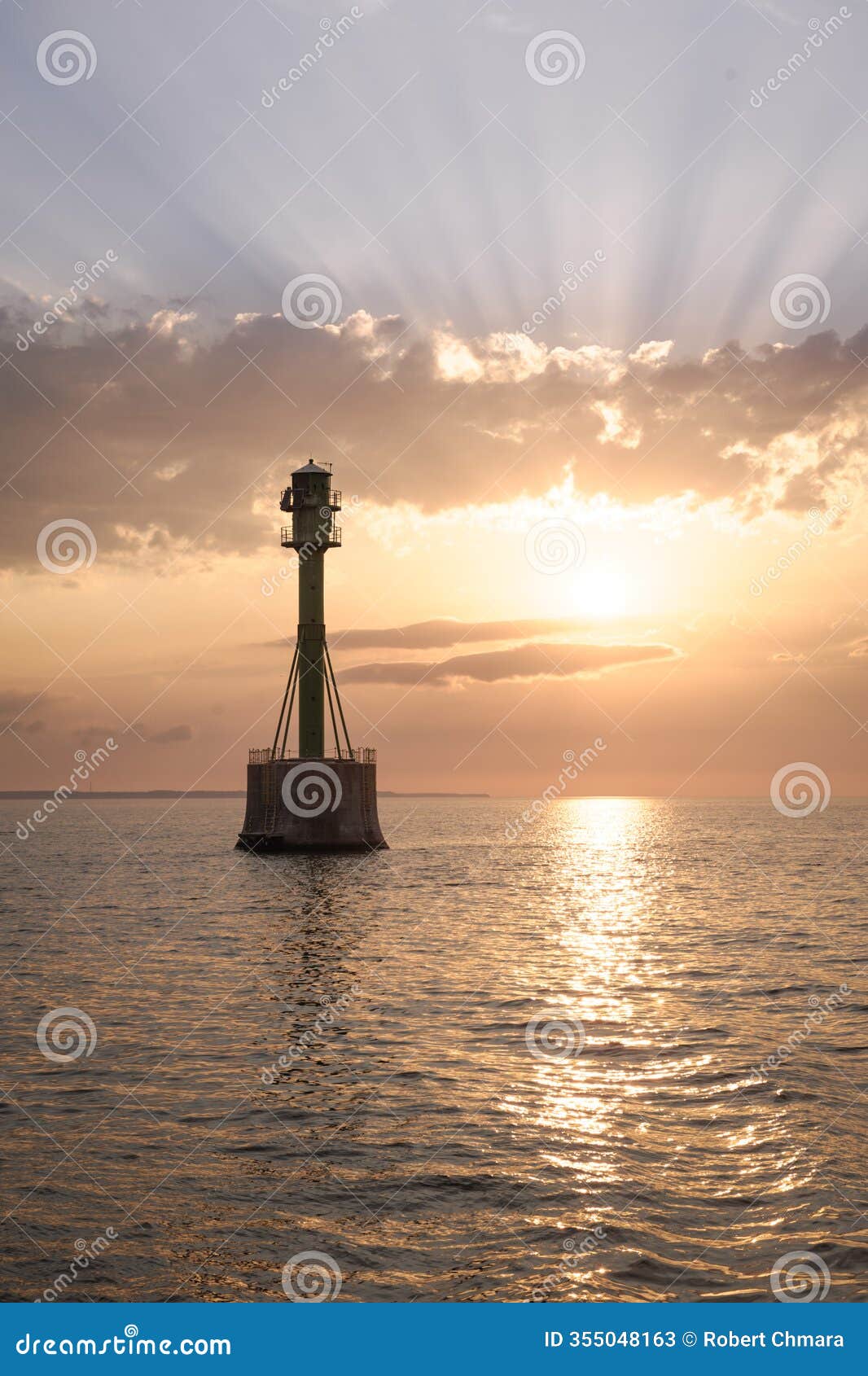 Lighthouse in the Ocean at Sunset with Sun Rays Stock Image - Image of ...