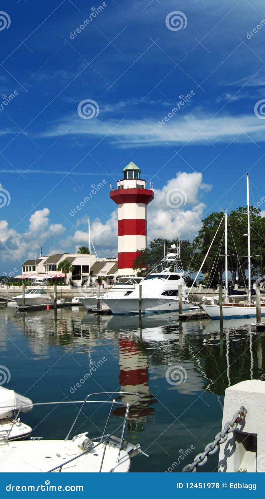Lighthouse over the marina stock photo. Image of clouds - 12451978