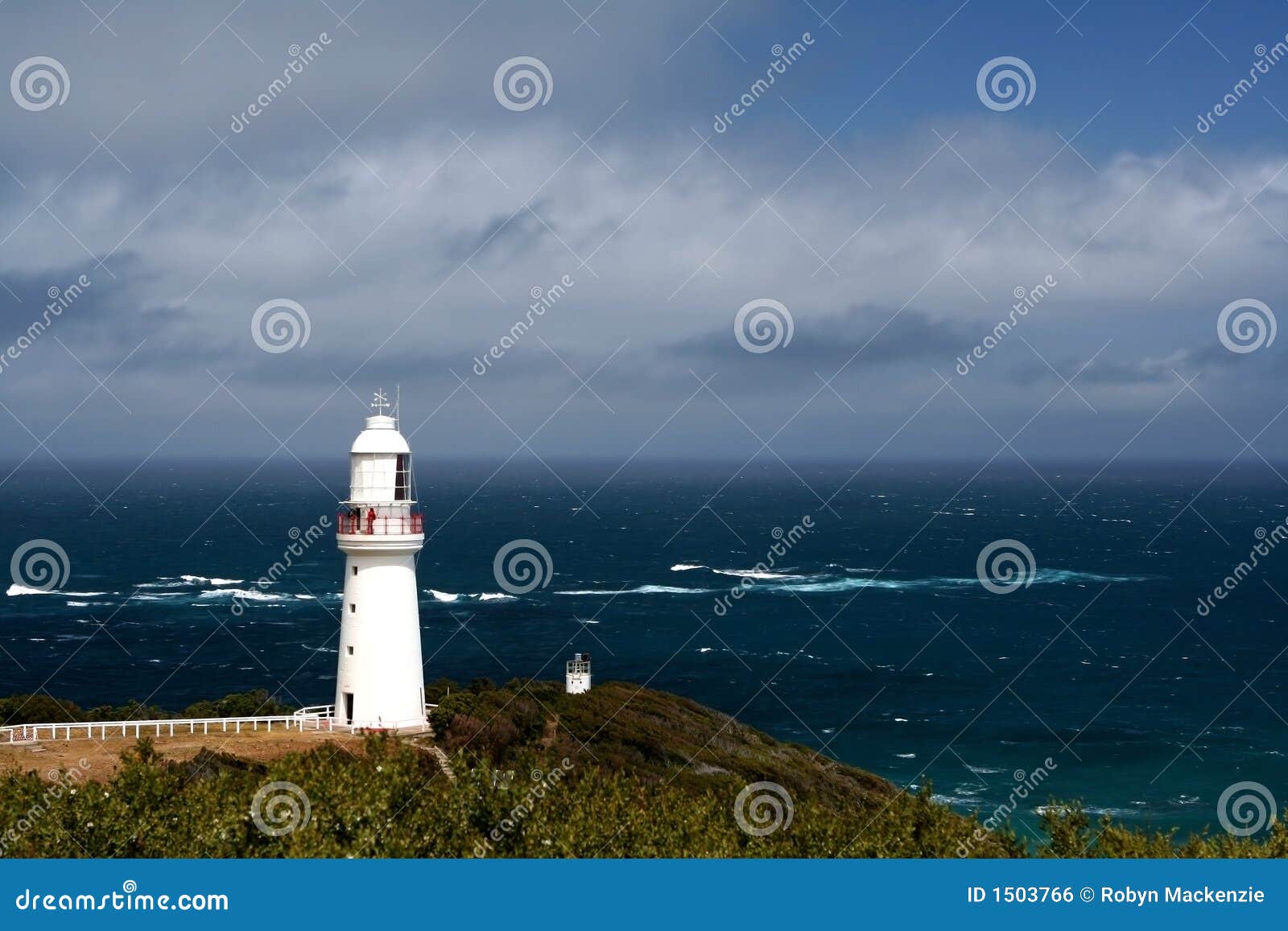 Lighthouse Overlooking Rough Blue Ocean Stock Photo - Image of cape ...