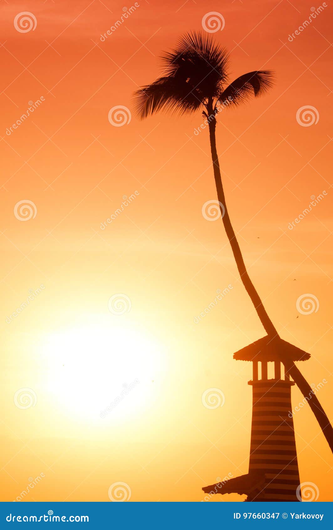 Lighthouse and Palm Tree on the Background of an Orange Sunset Stock ...